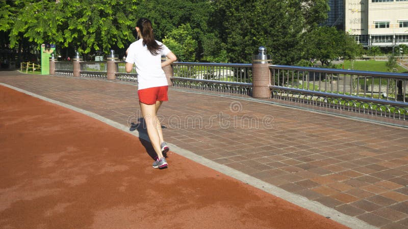 Girl is Running in the Running Way in the Garden Park. Editorial ...