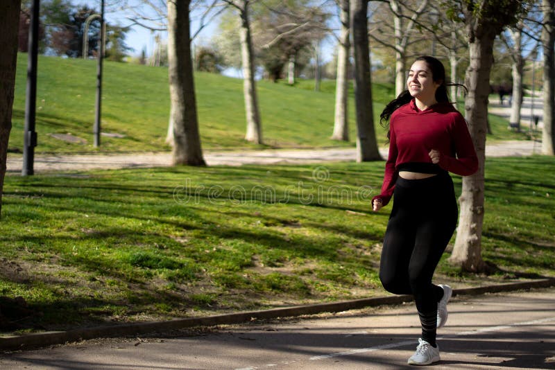 Girl Running and Smiling in a Park. Health and Training Stock Photo ...