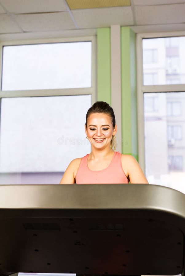 Girl Running on the Treadmill at the Gym Stock Photo - Image of ...