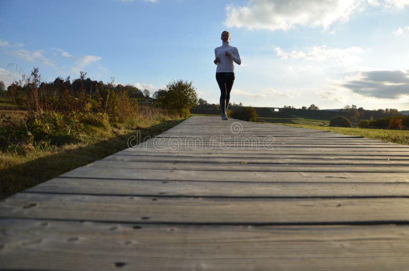 Girl Running Up on the Wooden Pavement Stock Photo - Image of motion ...