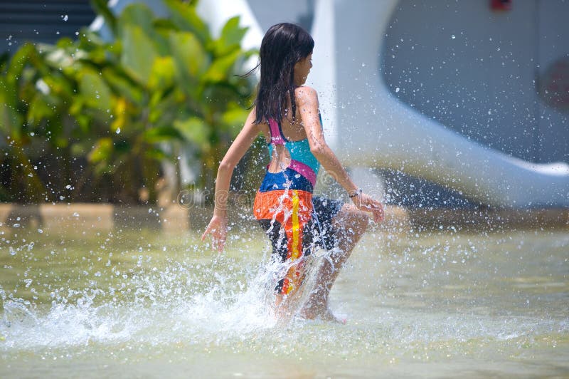 Girl Running through a Wading Pool at Water Park Stock Image - Image of ...