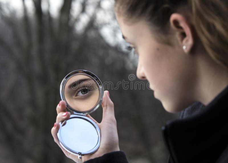 Girl S Eye in Compact Mirror Stock Photo - Image of eyelashes, hold ...