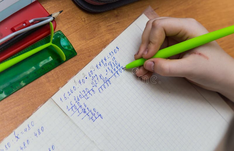 A Girl& X27;s Hand with a Ballpoint Pen Solve an Example in Mathematics ...