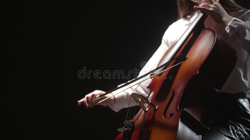 Girl S Hand Playing Cello, Closeup on Black Background. Cello Strings ...
