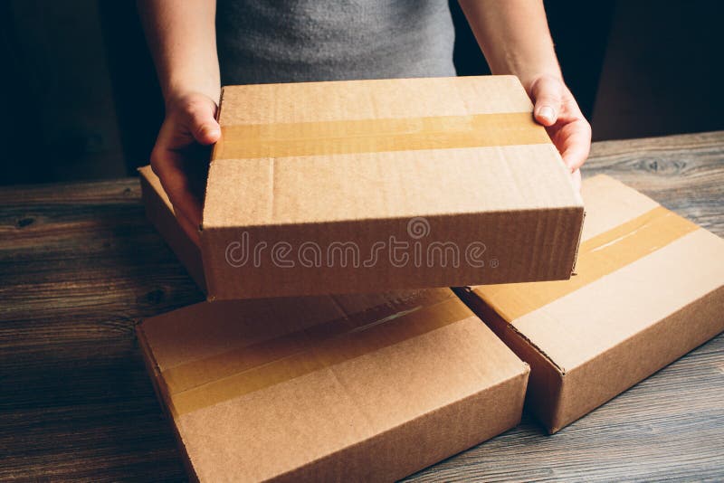 Girl S Hands Holding the Package on the Table. Stock Image - Image of ...