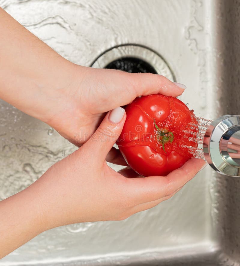 Girl& X27;s Hands Washing a Tomato in the Kitchen Stock Image - Image ...