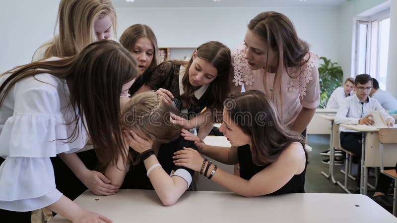 The Girl is a Schoolgirl Crying in Class and Her Classmates Console Her ...