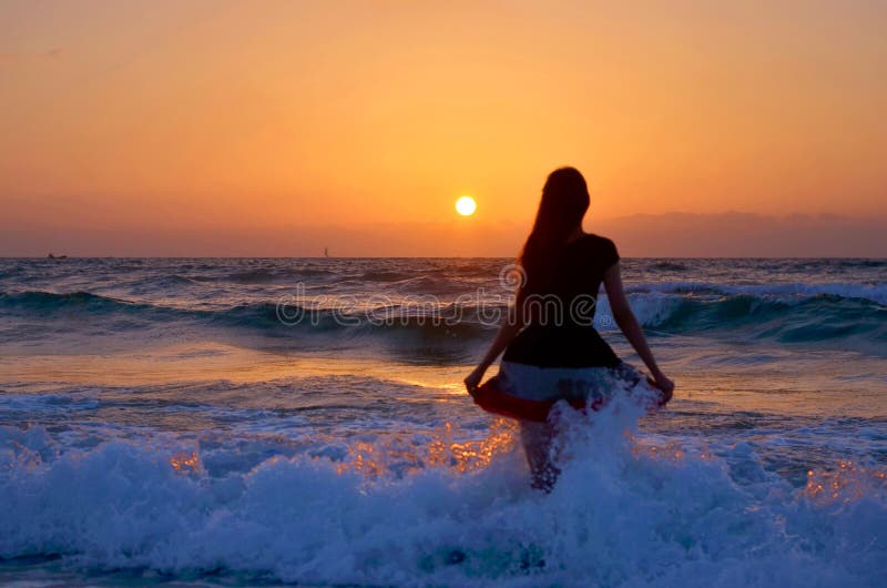Girl at sea wave on sunset editorial photography. Image of girl - 45190617