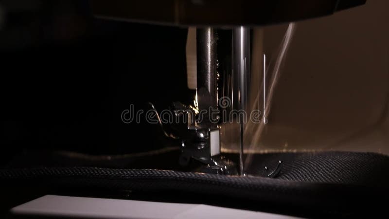 A Girl Sews on a Sewing Machine at Night in the Dark by the Light of a ...