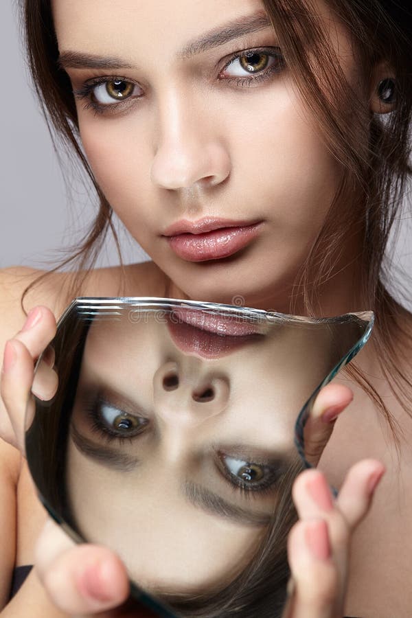 Female with Mirror Shard in Hand Posing on Gray Background. Face ...