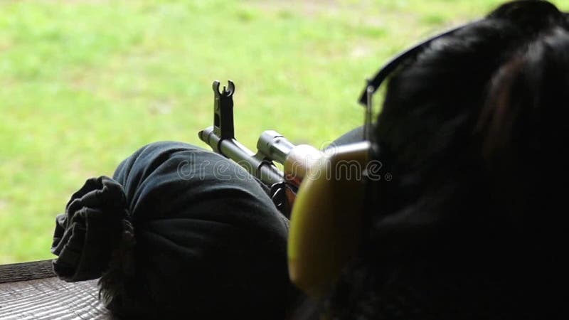 Girl Shoots with a Machine Gun in Slow Motion. Stock Video - Video of ...