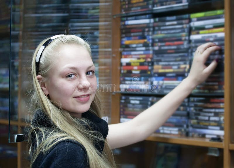 Girl in shop chooses disk stock photo. Image of groceries - 14039240