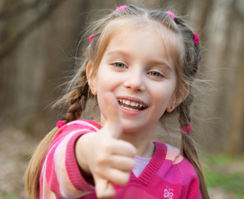 Girl showing a thumbs up stock image. Image of adorable - 25324455