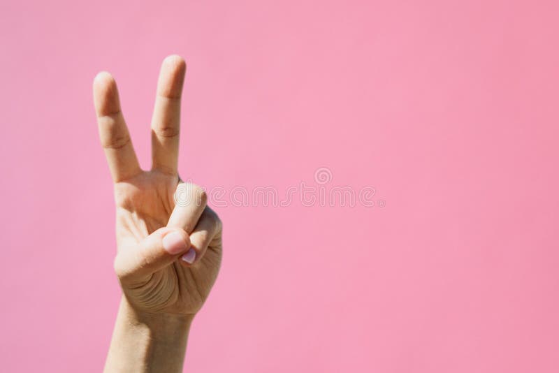 Girl shows peace sign stock image. Image of background - 143937697