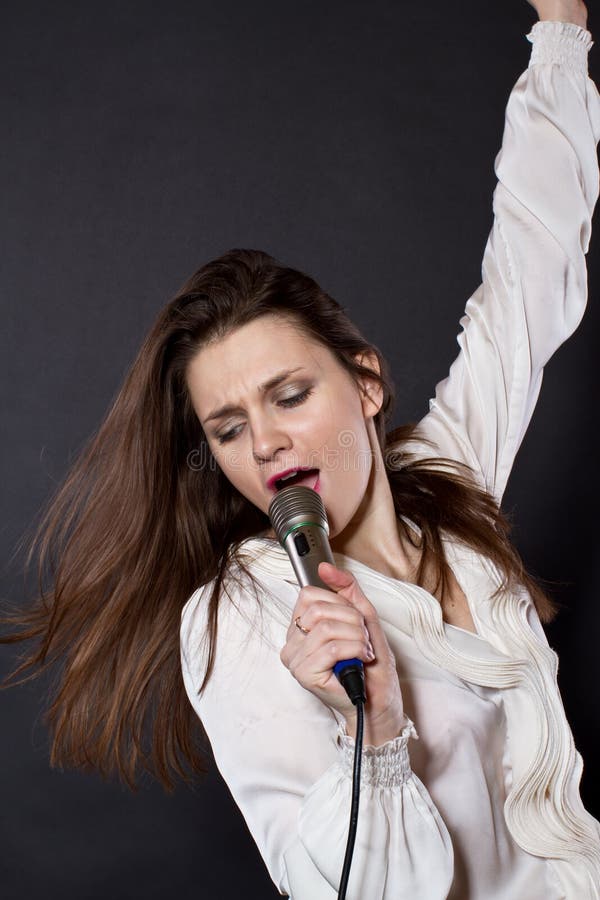 Girl Singing into a Microphone Stock Image - Image of girl, face: 28845061