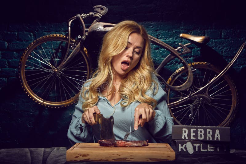 The Girl Eats Meat in a Restaurant. Expressive Stock Photo - Image of ...