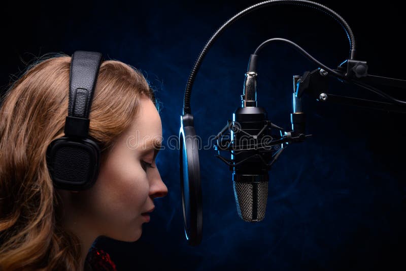 The Singer Sings with a Microphone in the Recording Studio. Stock Image ...