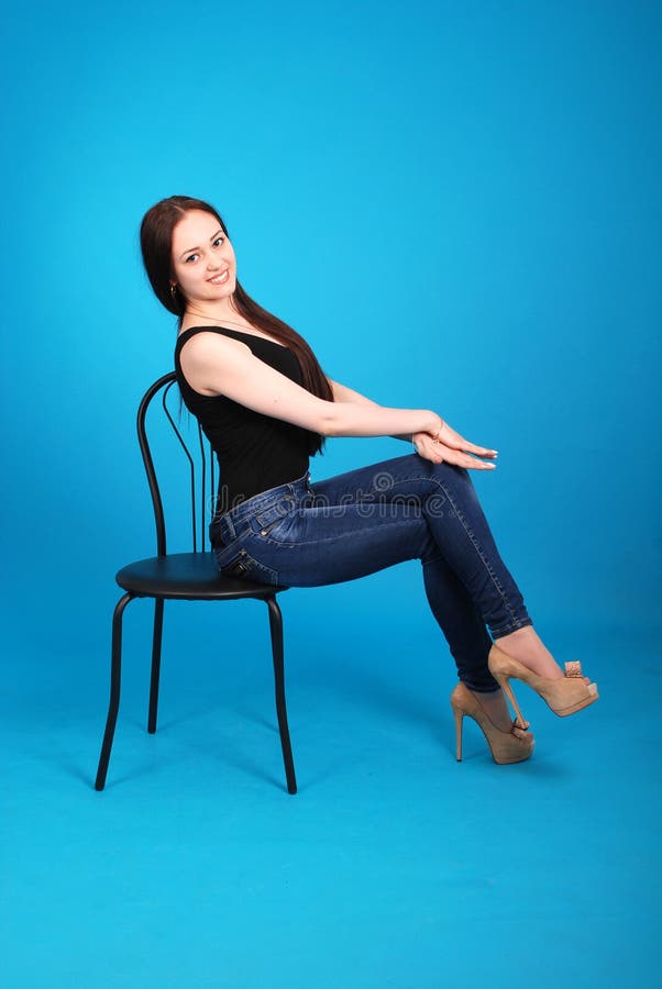 Girl Sits on a Chair and Holding a Tablet Computer Stock Photo - Image ...