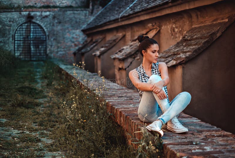 Girl Sitting Alone on the Wall and Thinking Stock Image - Image of ...
