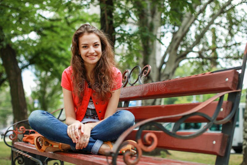 Girl sitting on a bench stock image. Image of summer - 109343103