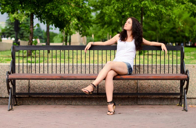 Girl sitting on a bench stock photo. Image of dark, little - 26384364