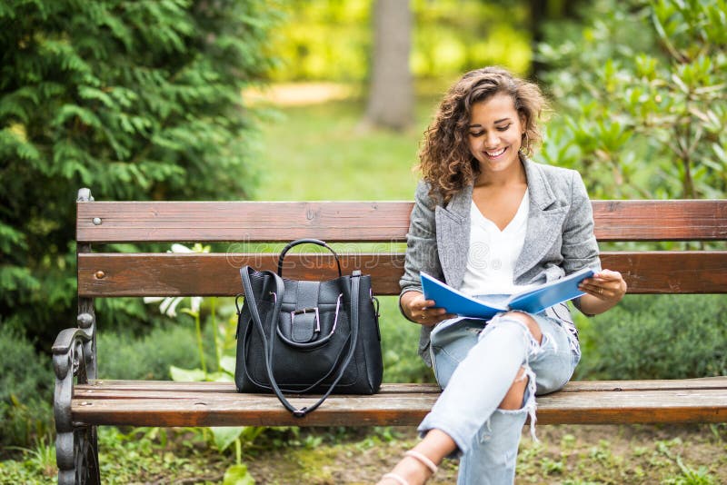 The Girl Sitting on a Bench, Reading a Book Stock Image - Image of life ...