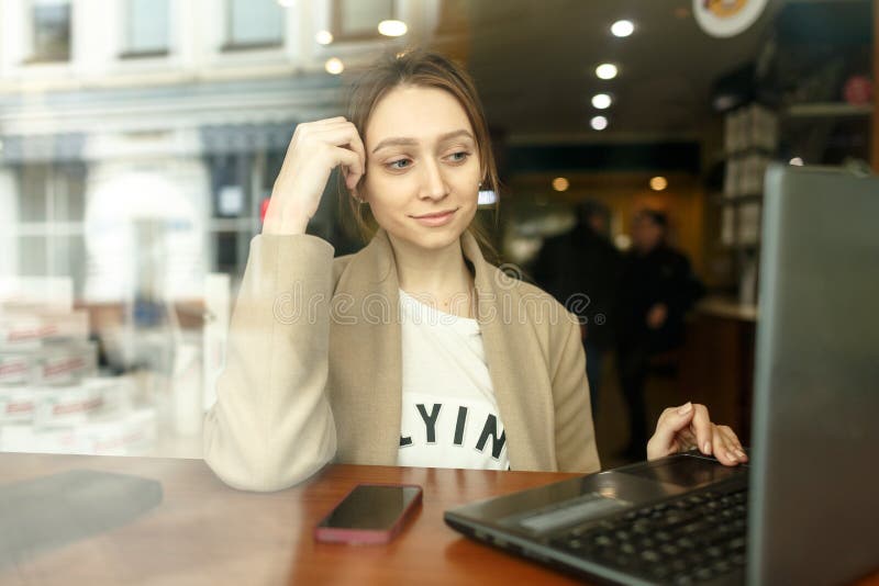 Girl Sitting at a Cafe Table with a Laptop Computer Stock Image - Image ...