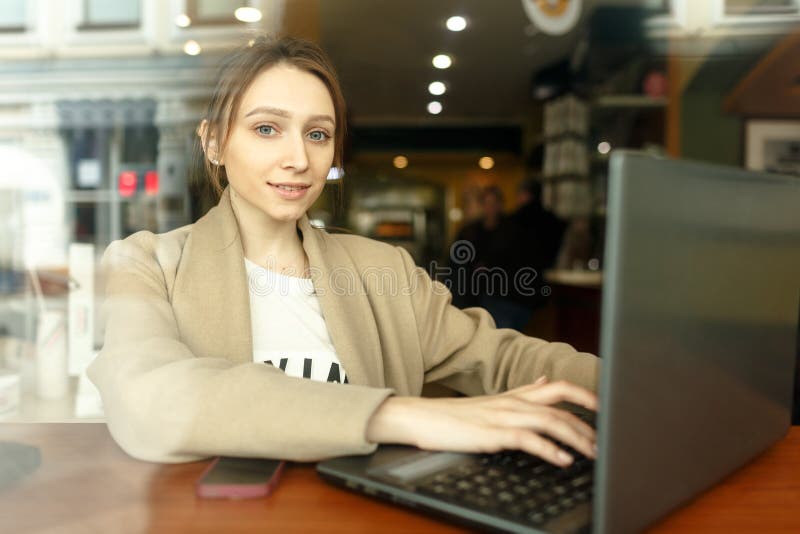 Girl Sitting at a Cafe Table with a Laptop Computer Stock Image - Image ...
