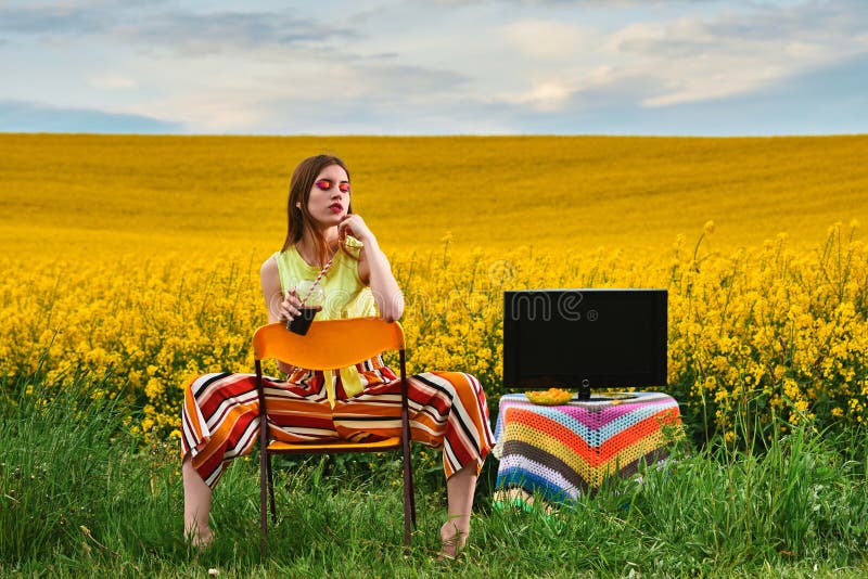 Girl Sitting on a Chair with a Drink in the Field. Stock Photo - Image ...