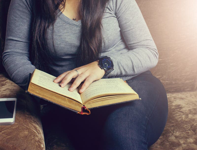 Girl Sitting on Couch Reading a Book Stock Image - Image of portrait ...