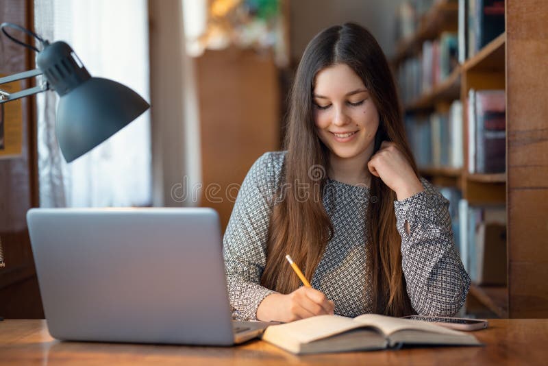 Smiling Young Female Student Studying at the College Library Stock ...