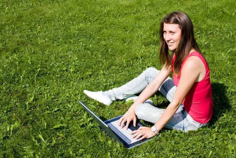 Girl Sitting Down on the Grass with Her Laptop Stock Photo - Image of ...