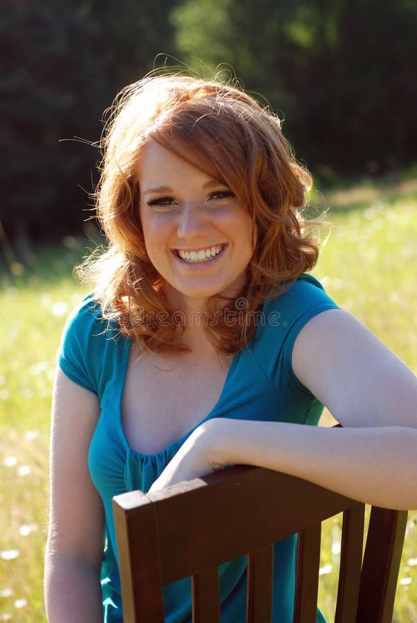 Girl Sitting in Field of Grass - Vertical Stock Photo - Image of white ...