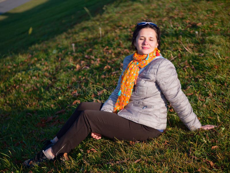 Girl Sitting on Grass in Autumn Outdoors Stock Image - Image of drink ...