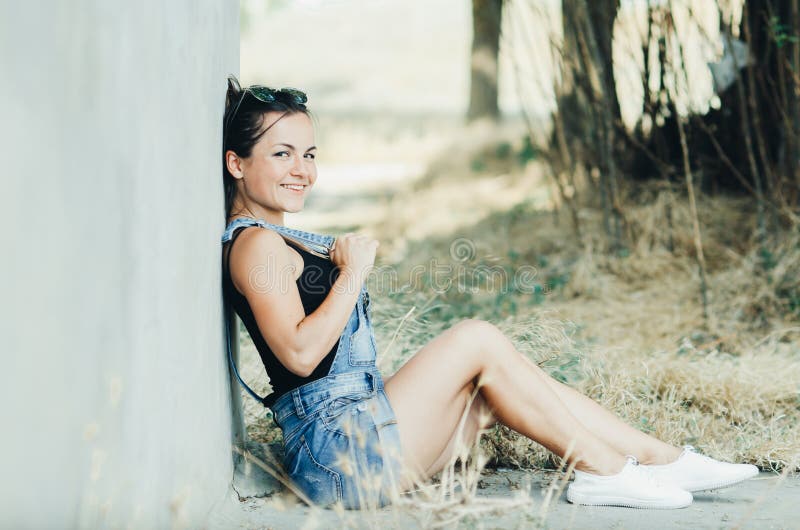 The Girl on the Grass in Overalls Stock Photo - Image of human, beauty ...