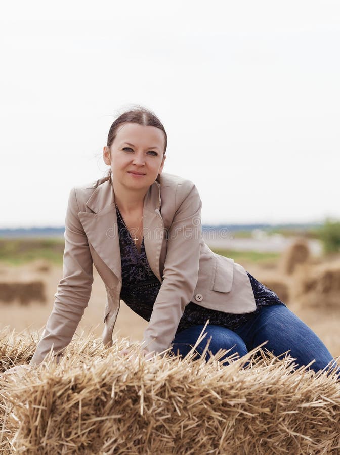 Girl sitting on a haystack stock photo. Image of lifestyle - 33103414