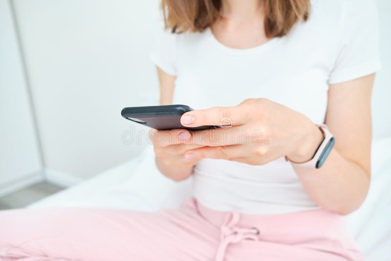 Girl Sitting at Home Typing a Message on the Phone Stock Image - Image ...