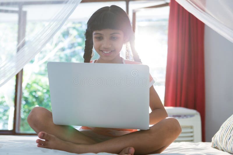 Girl Sitting with Laptop on Bed at Home Stock Image - Image of ...