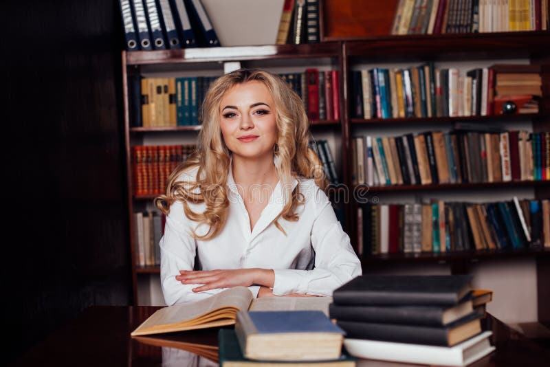 The Girl Sitting in the Library Reading Books is Preparing for the Exam ...