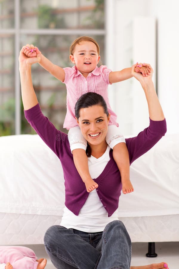 Girl Sitting on Mother S Shoulders Stock Image - Image of doll, baby ...
