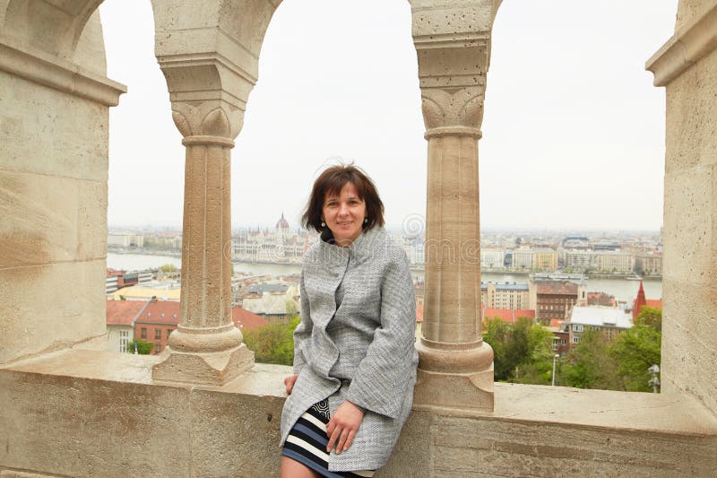 The Girl is Sitting on a Parapet with Columns. Stock Photo - Image of ...