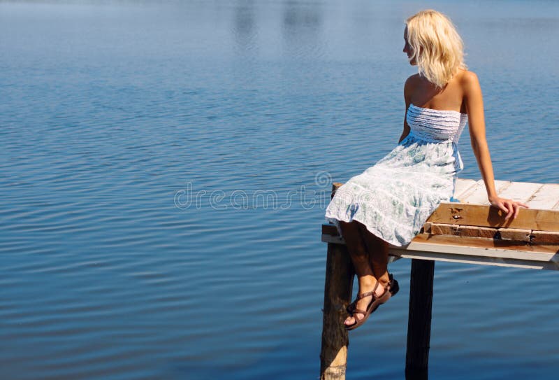 Girl Sitting on a Pier at the River Bank Stock Image - Image of light ...