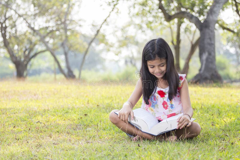 Girl Sitting Reading a Book. Stock Photo - Image of grass, book: 51437700
