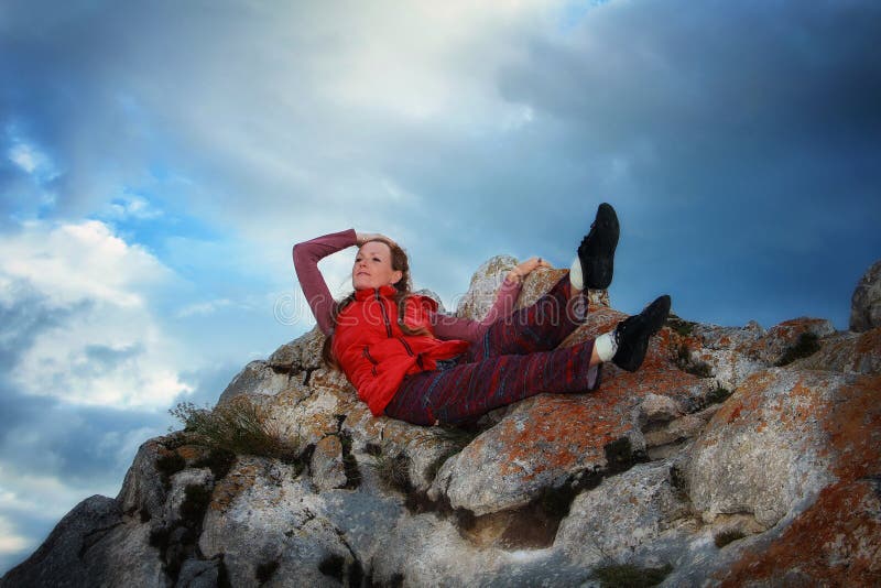 Girl sitting on a rock stock photo. Image of rock, terrain - 196555544