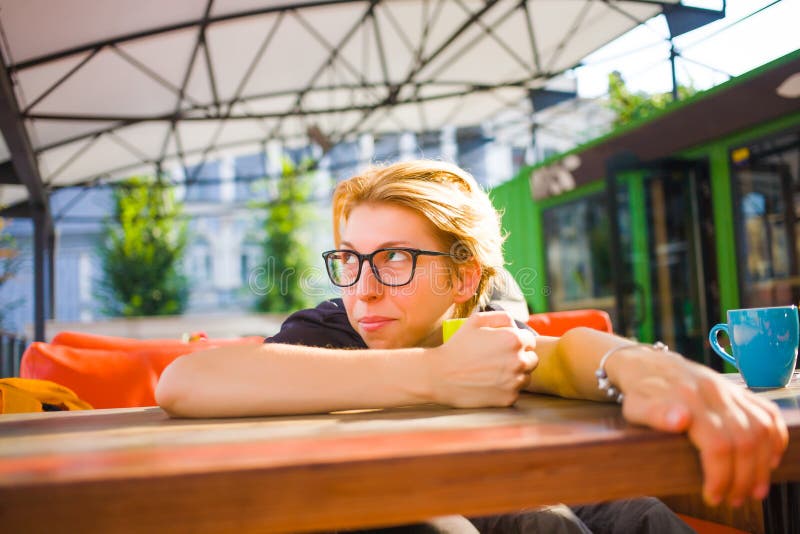 The Girl Sitting at the Table. Stock Image - Image of laptop, looking ...