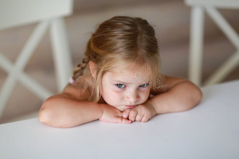 Girl sitting at the table stock photo. Image of household - 57985318