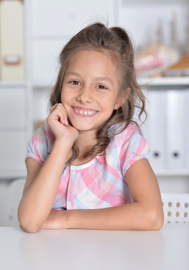 Girl sitting at table stock image. Image of elementary - 96883577