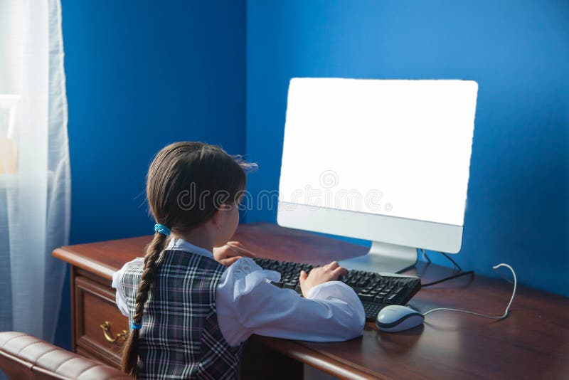 Girl is Sitting at the Table and Working and Studying at the Computer ...