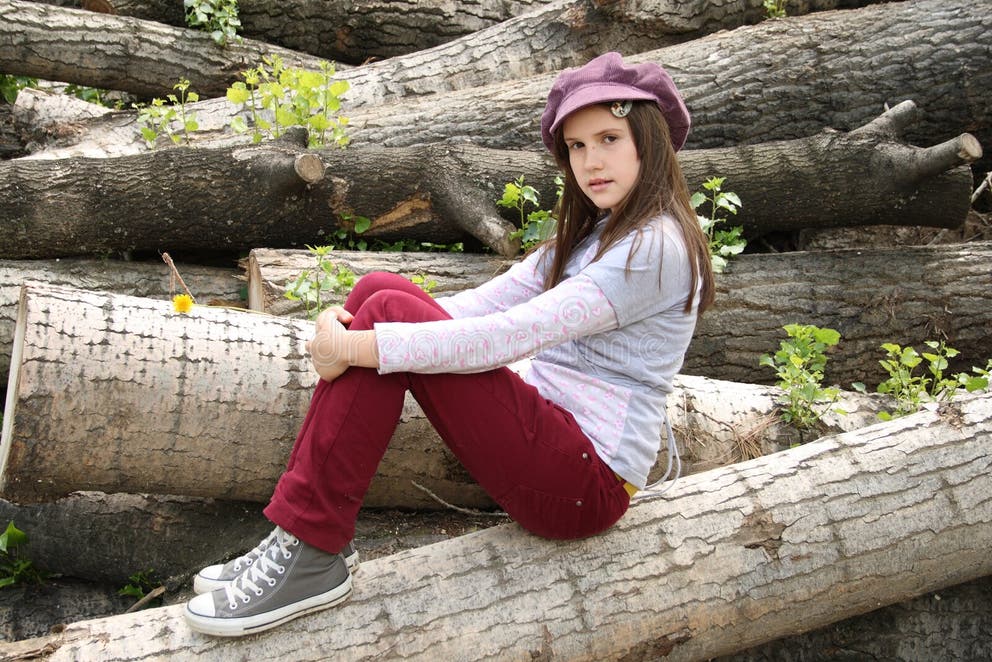 Girl Sitting on Timber Logs Stock Photo - Image of lies, colored: 14616456