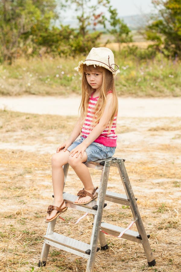 Girl Sitting on Top Stepladder Outdoors Stock Photo - Image of step ...